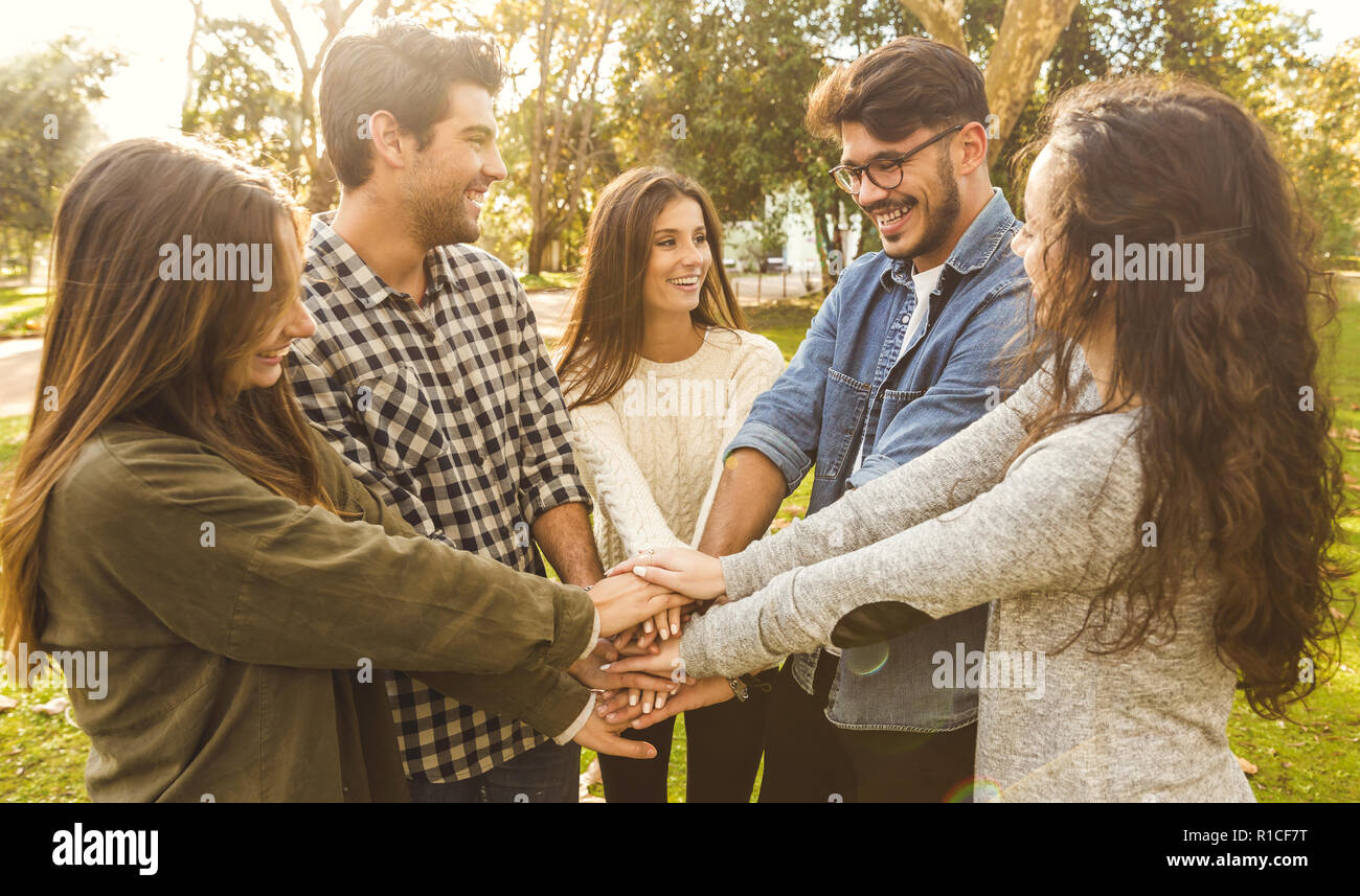 Group of friends joining their hands together Stock Photo - Alamy