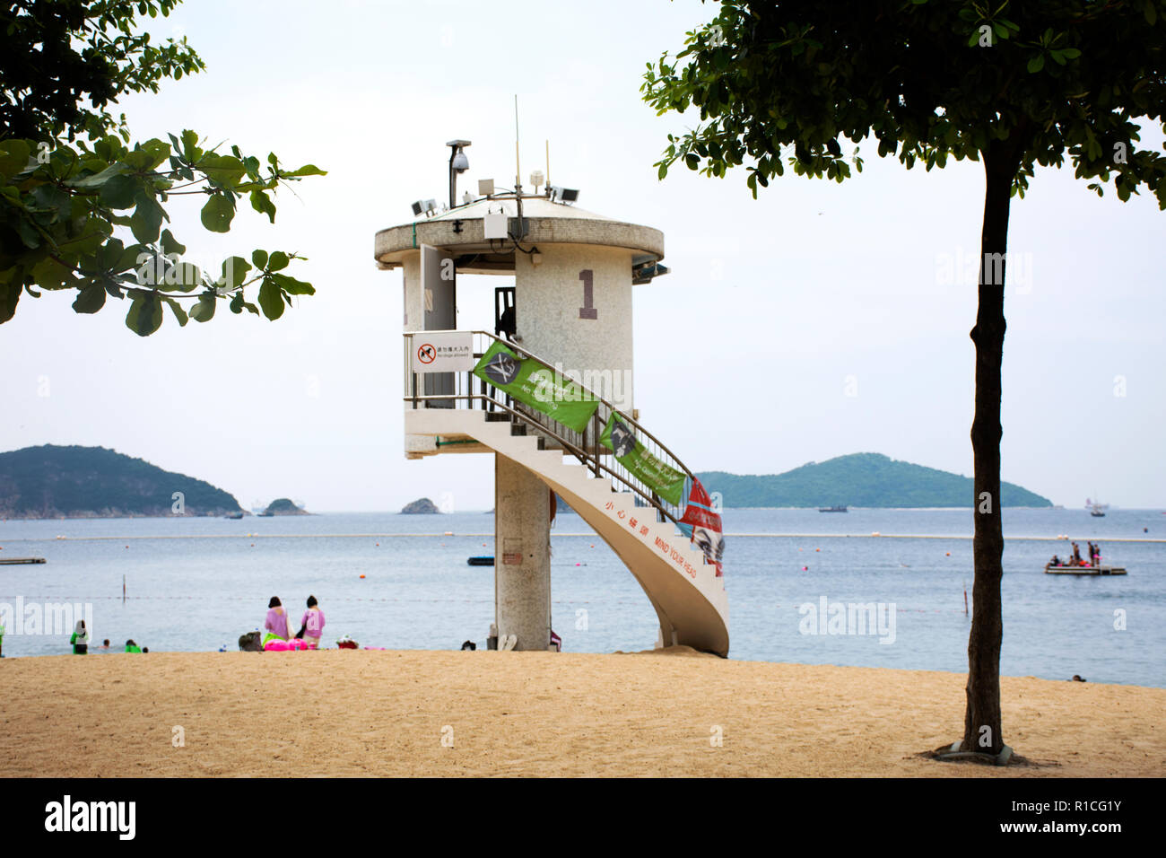 Enclosed lifeguard tower with Chinese people and foreigner travelers ...