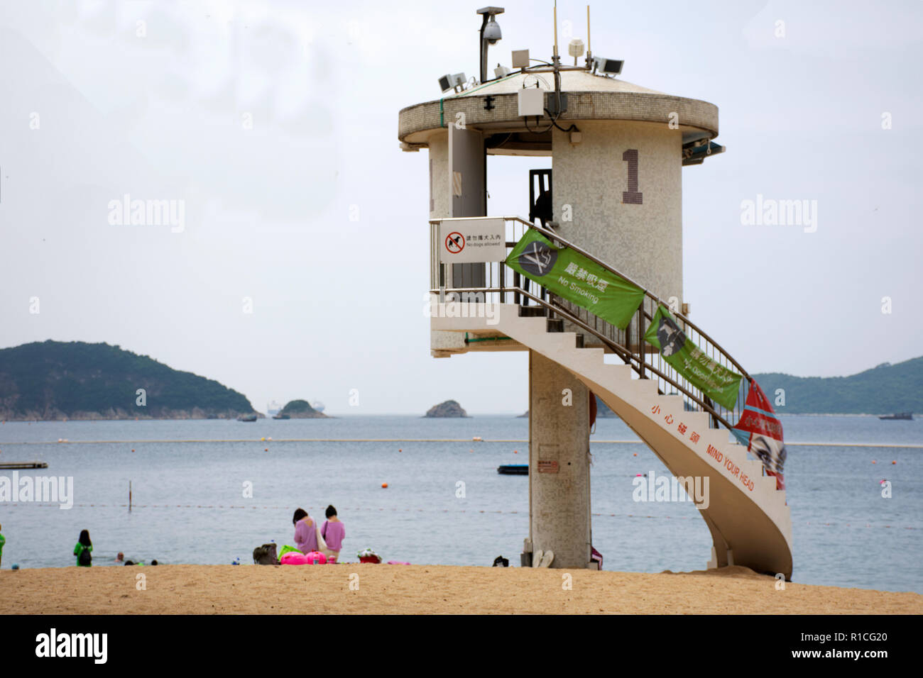 Enclosed lifeguard tower with Chinese people and foreigner travelers ...