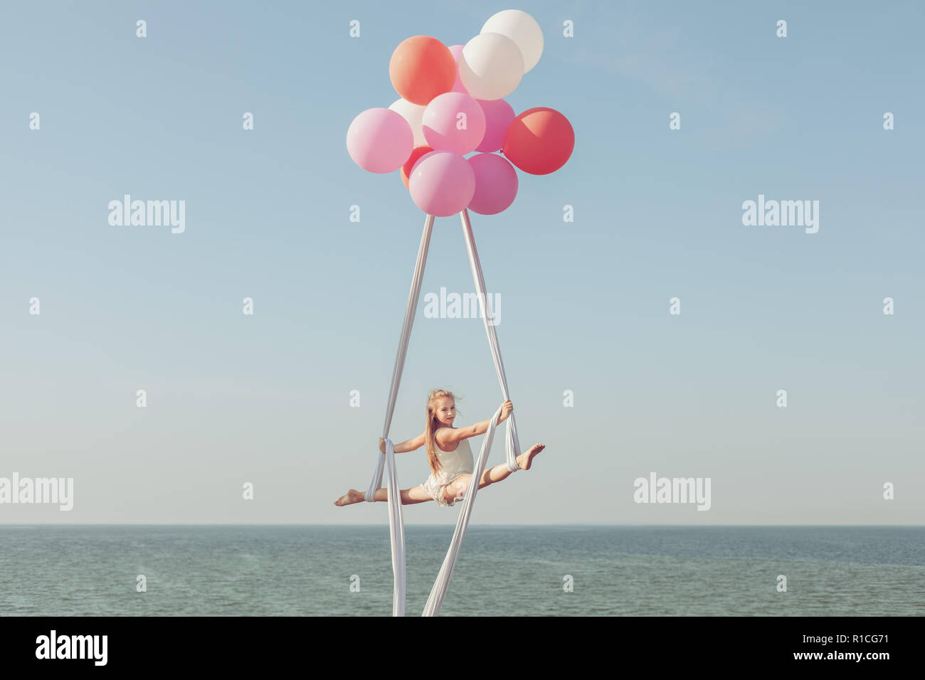 Little girl acrobat makes the twine on the canvases Stock Photo - Alamy
