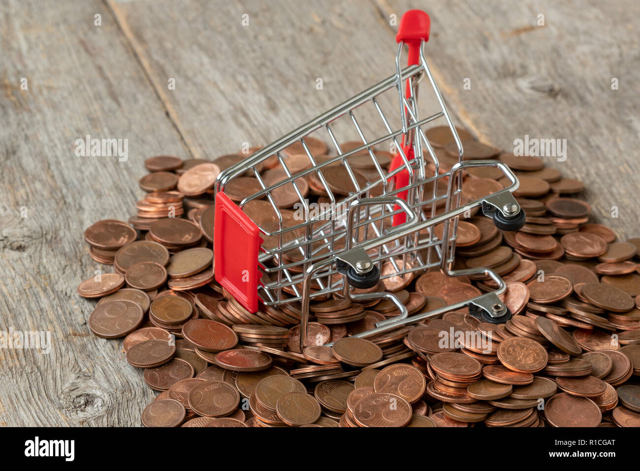 Overturned shopping cart and scattered coins Stock Photo - Alamy