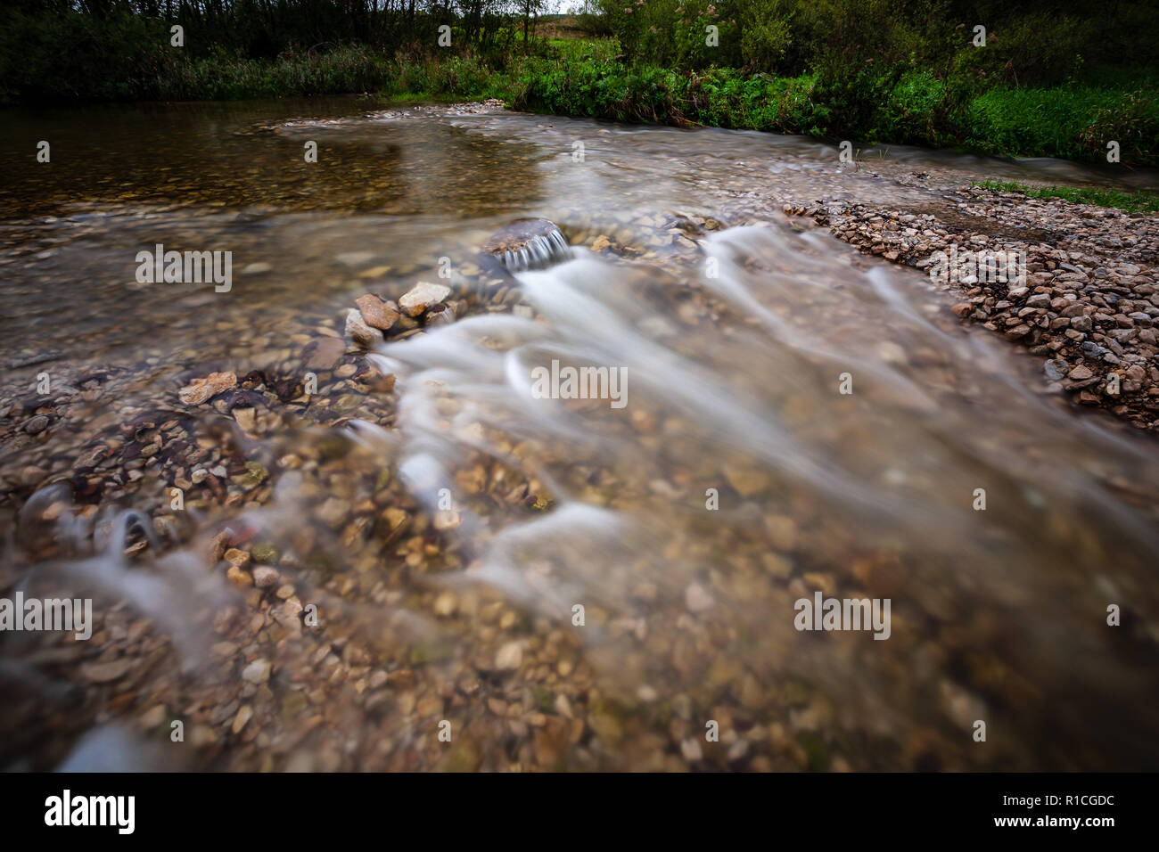 long exposure rocky mountain river in summer with high water stream ...