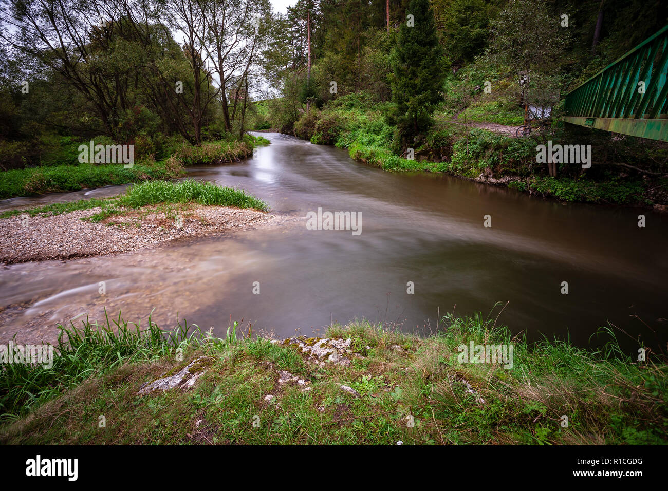 long exposure rocky mountain river in summer with high water stream ...