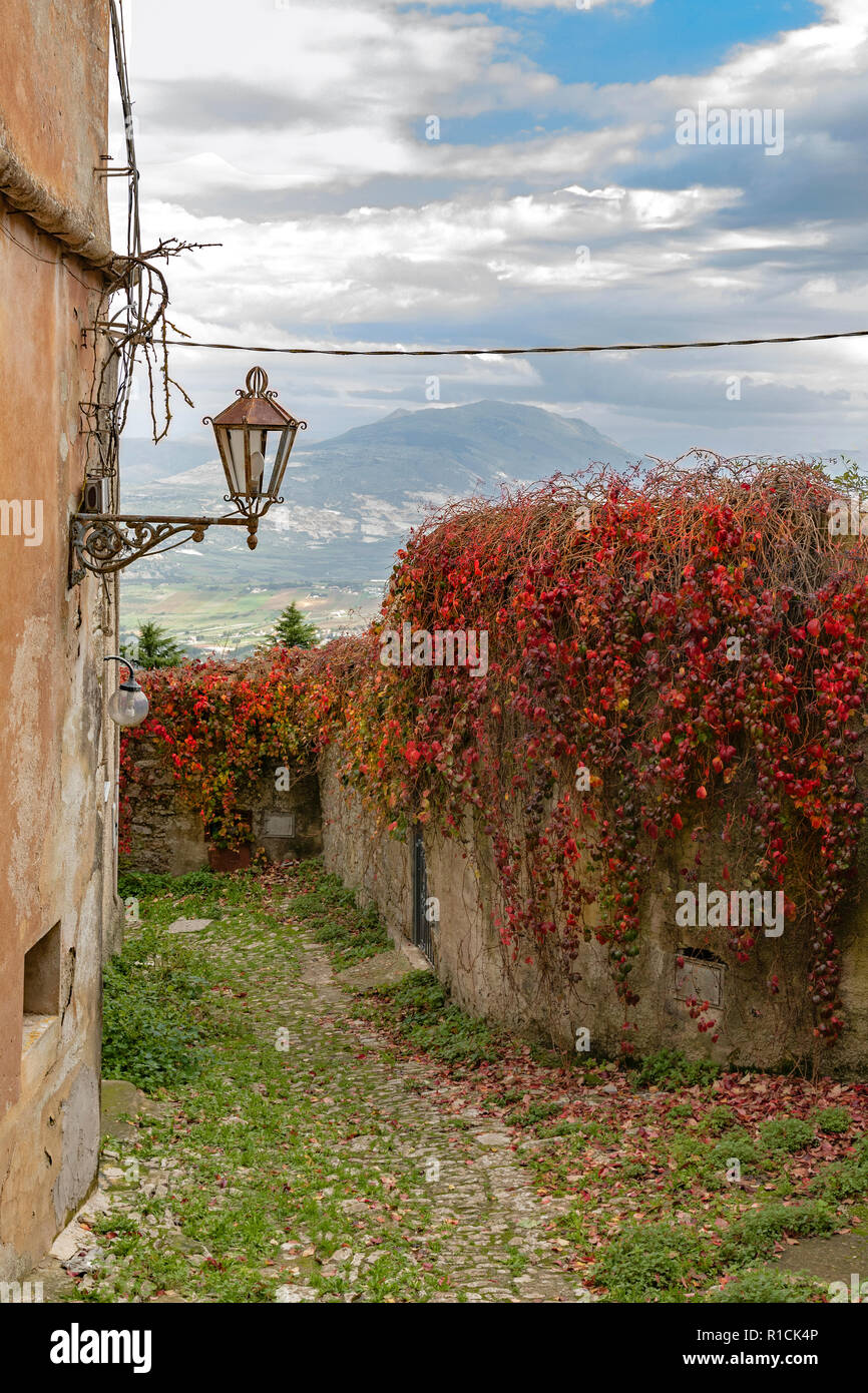 Narrow street with distant view of Trapani, in the medieval walled town ...