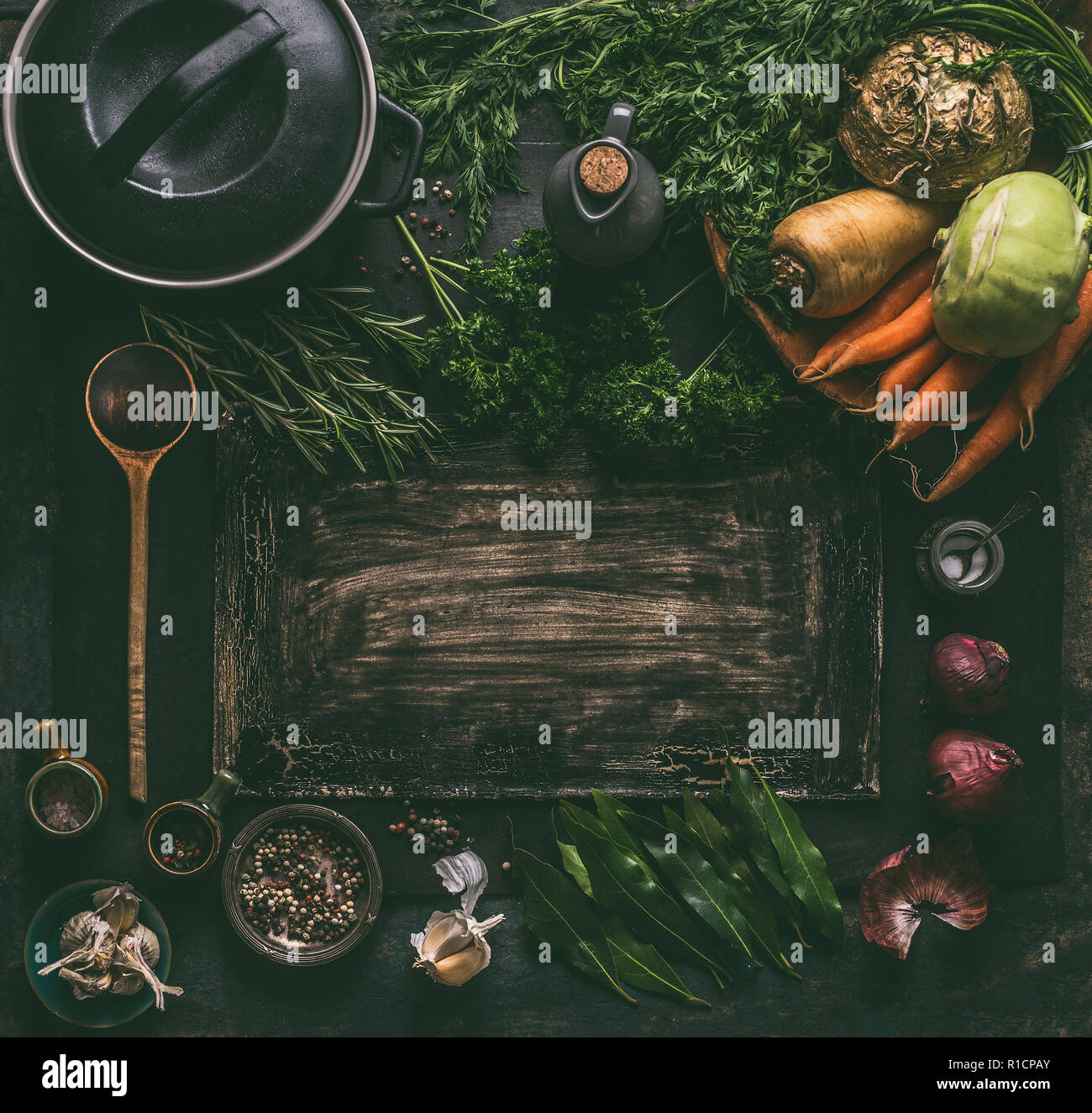 Dark rustic food background frame with vegetarian ingredients: root ...
