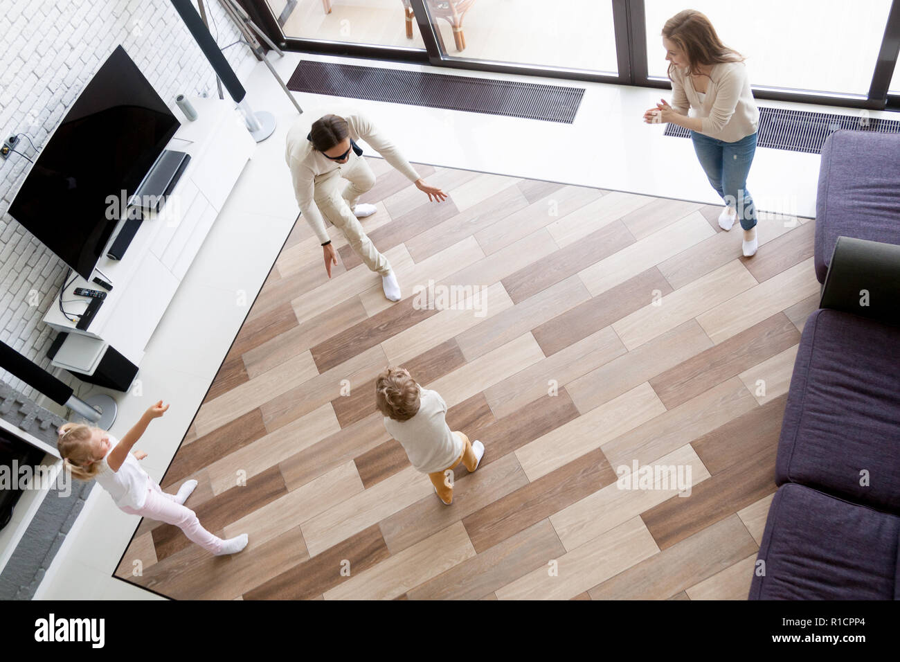 Happy family playing hide and seek at home Stock Photo - Alamy