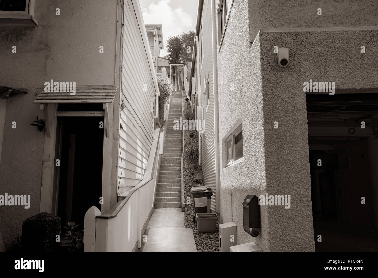 Stairs leading upwards between two tall walls in monochrome Stock Photo ...