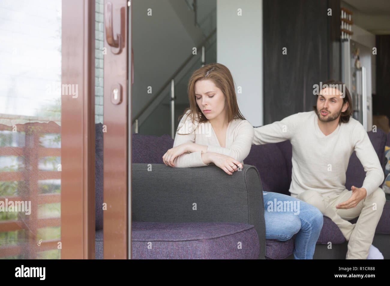 Young man and woman quarreling at home Stock Photo - Alamy