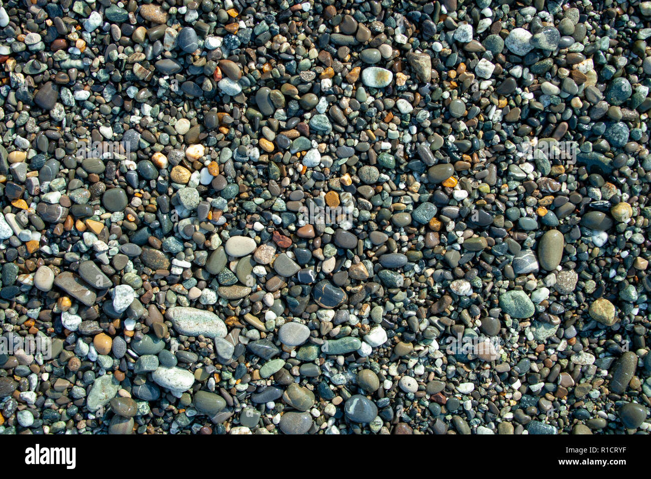 Multi colored stones on beach. Stones background for design Stock Photo ...