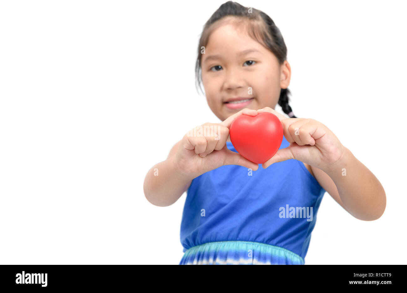 Cute asian girl show little red heart in hand isolated on white ...