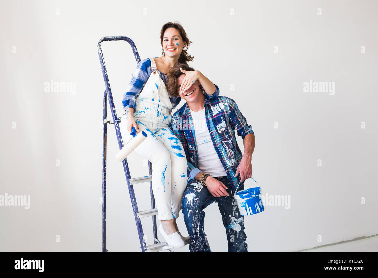 Repair, family and renovation concept - Funny young woman and man ...