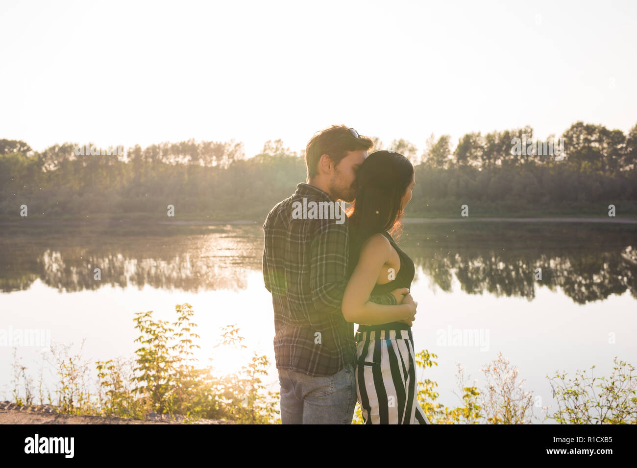 People, love and nature concept - Young beautiful woman and handsome ...