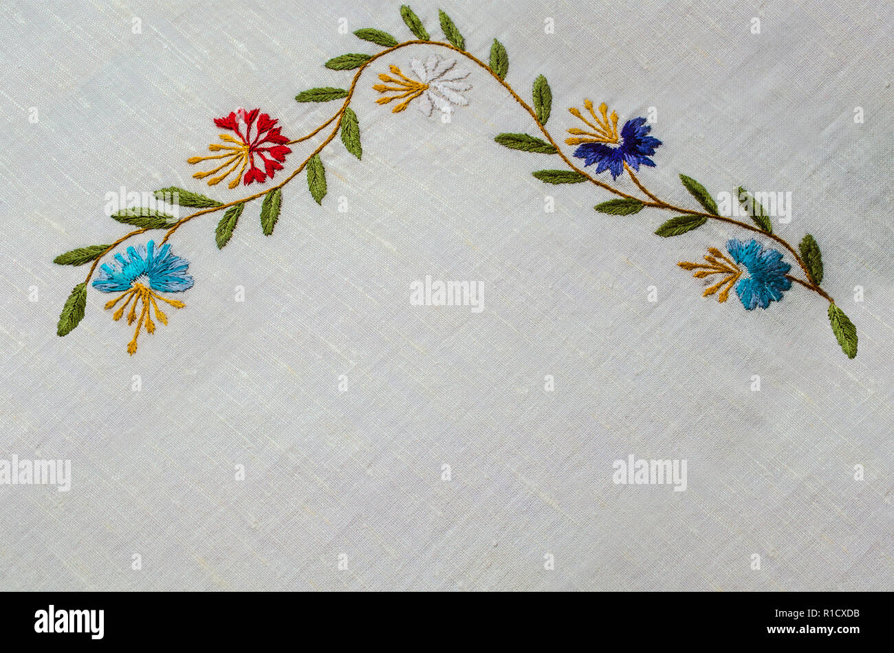 Yerevan, Armenia, June 04, 2018: Corner with border of undulating branches with the wild flowers ...