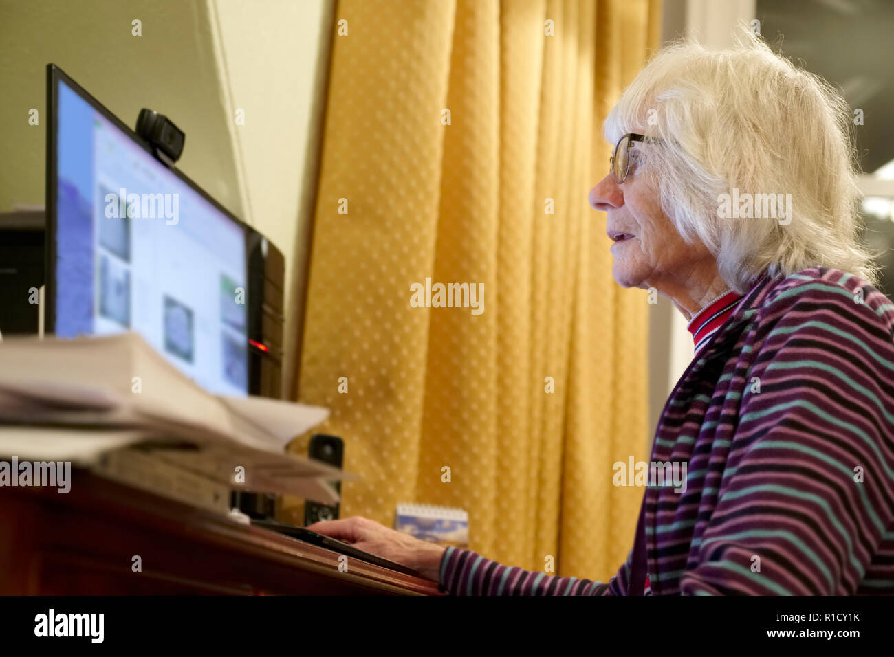 Old elderly senior person learning computer and online internet skills ...
