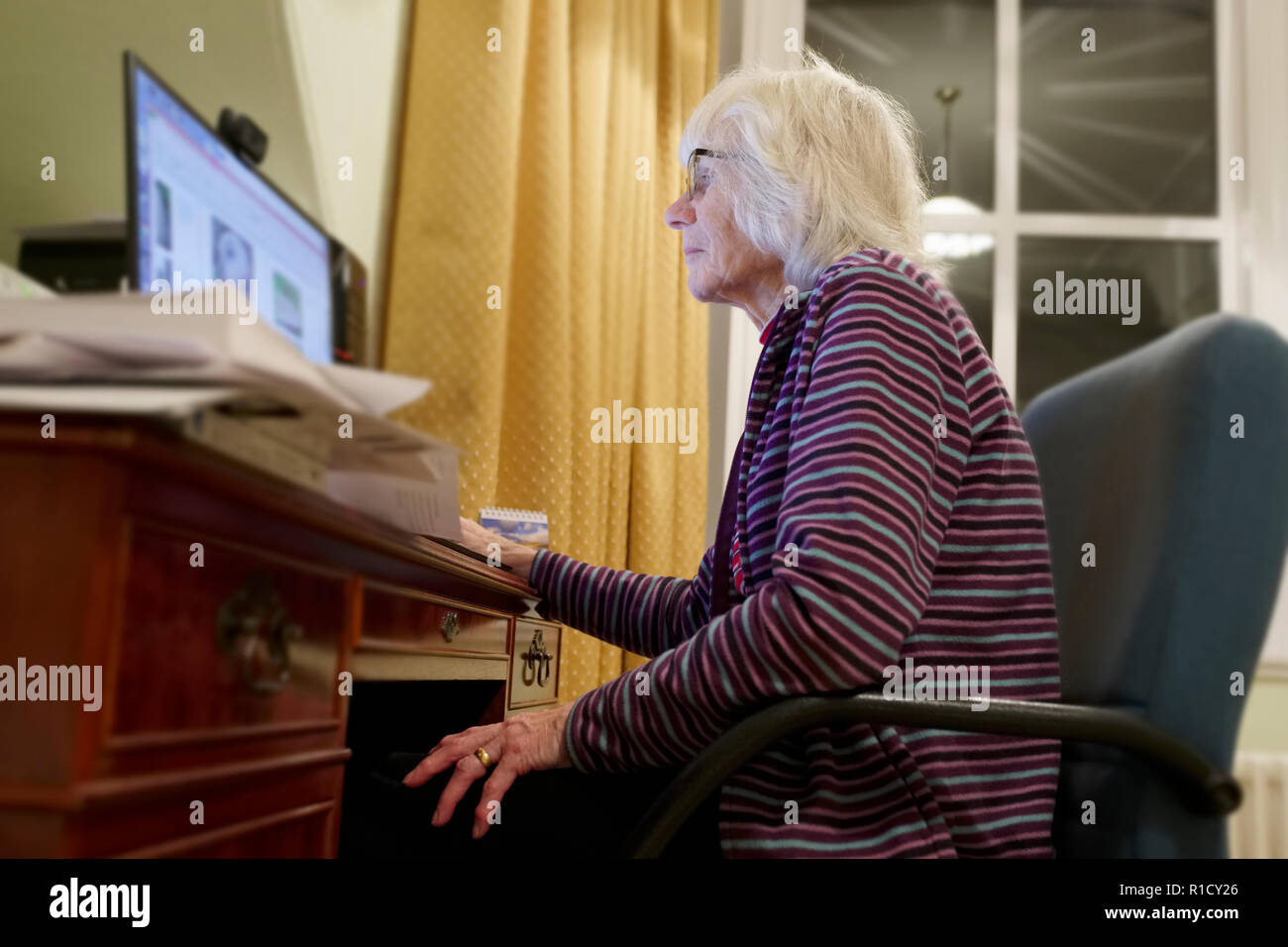 Old elderly senior person learning computer and online internet skills ...