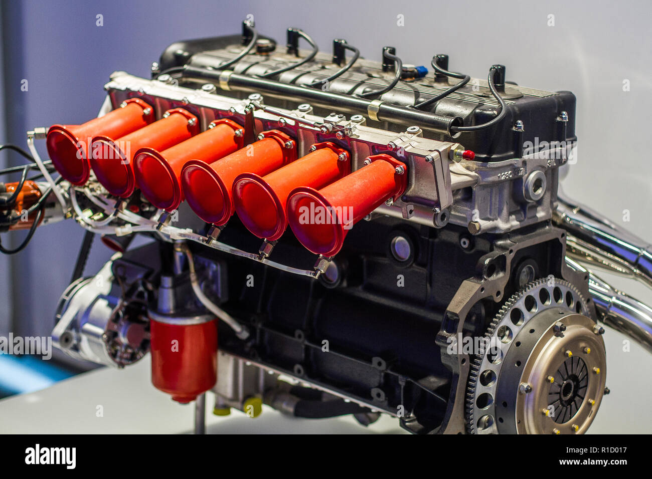 Legendary motorsport engine with red pipes on throttles Stock Photo - Alamy