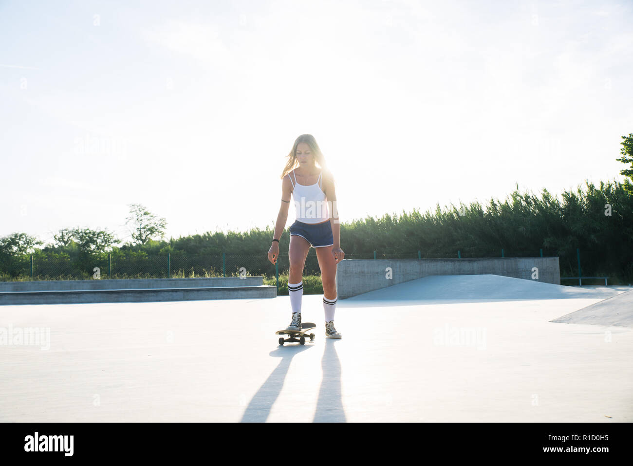 Stylish young woman skating outdoors - Pretty female skater playing ...