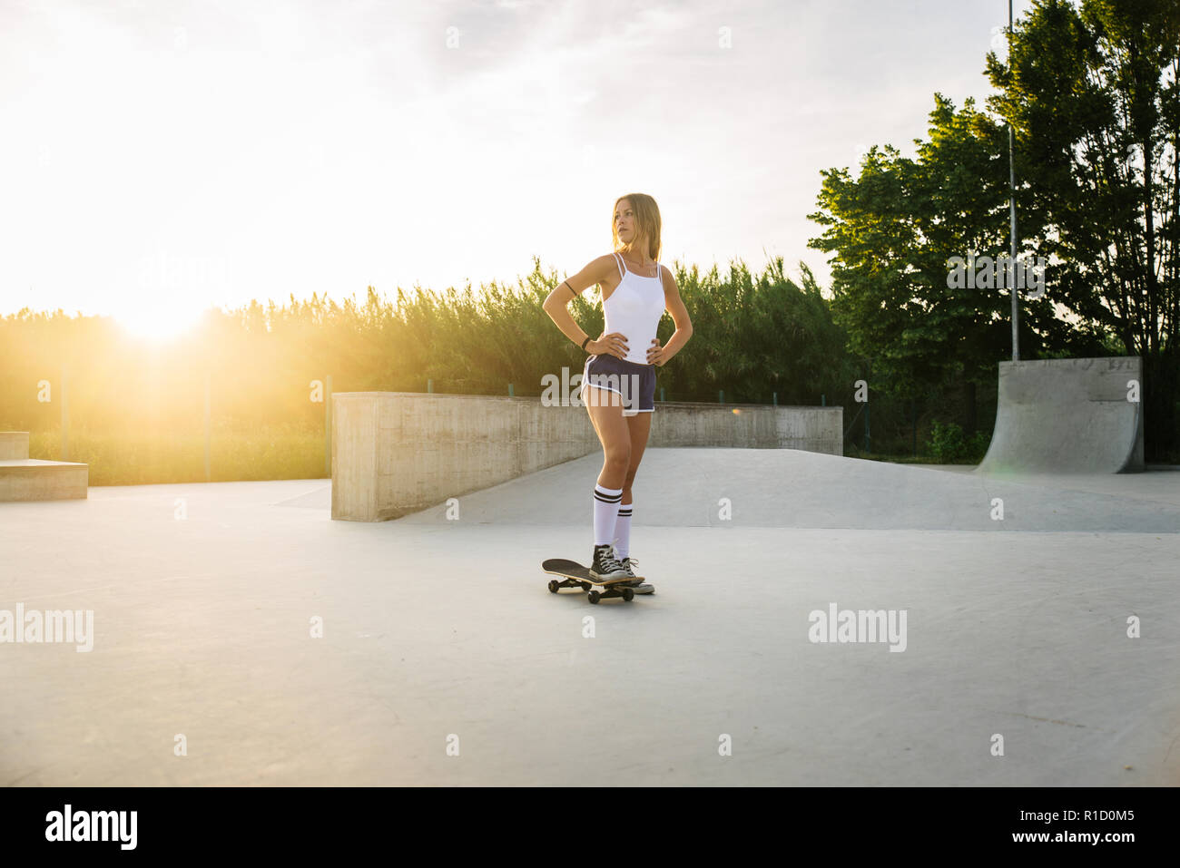 Stylish young woman skating outdoors - Pretty female skater playing ...