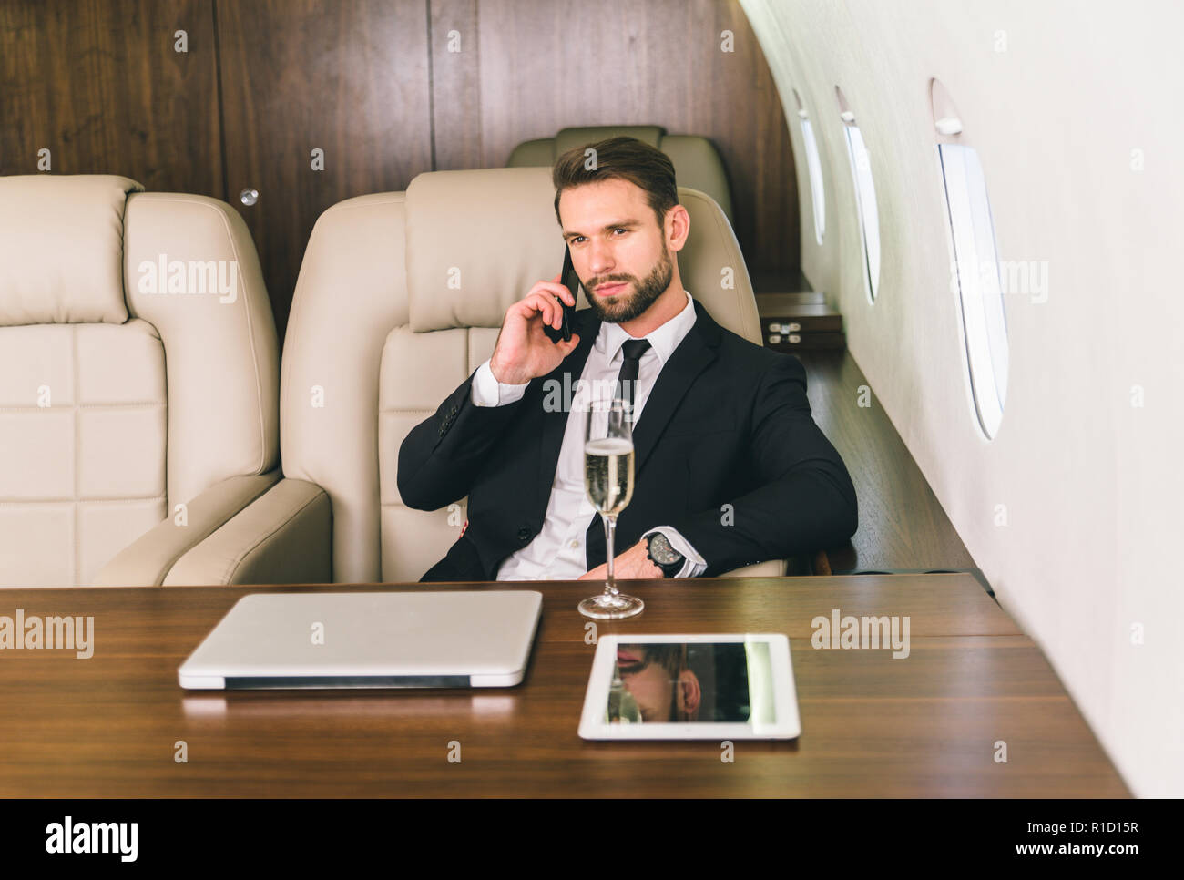 Businessman working while travelling on private jet - Portrait of ...
