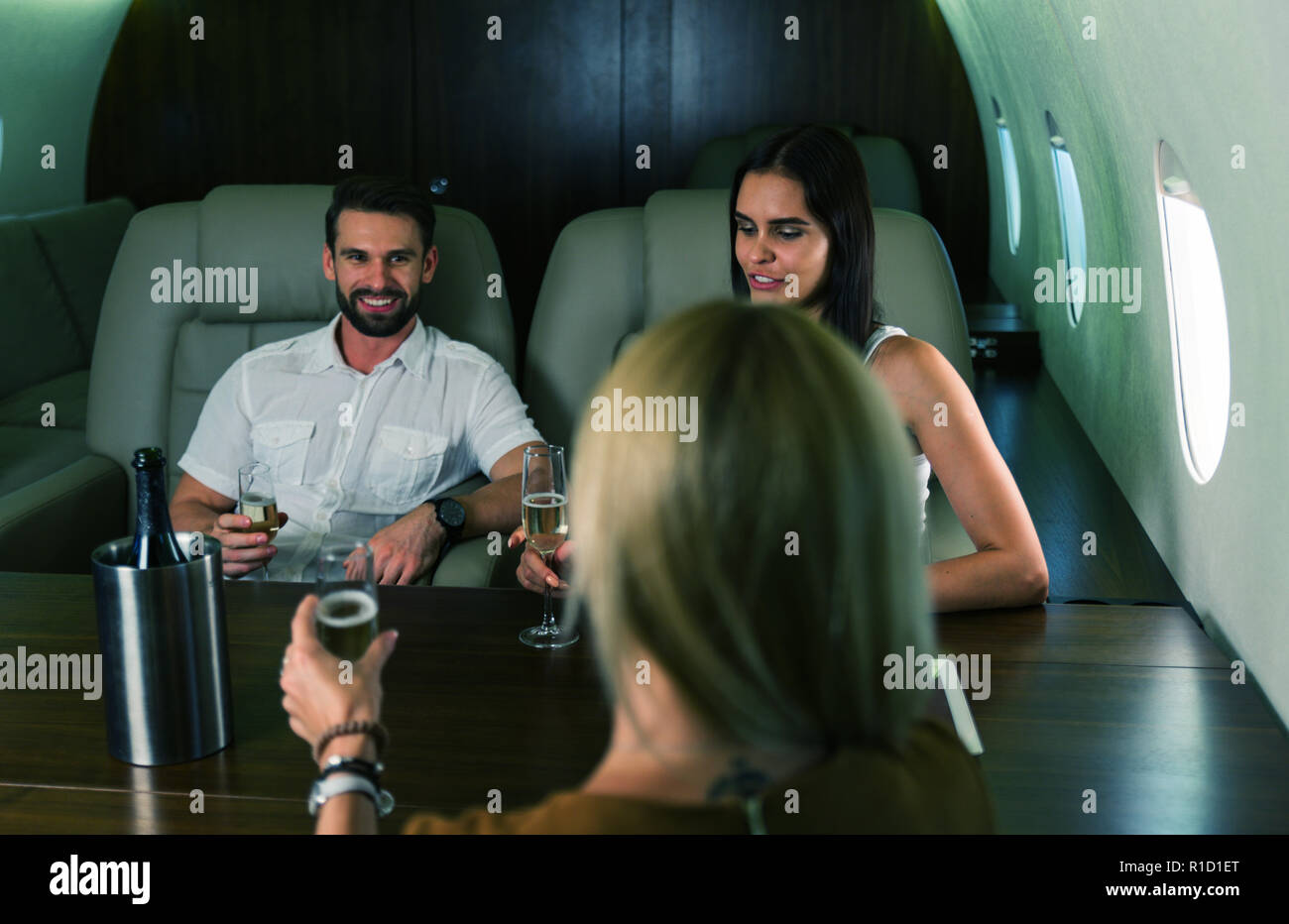 Happy group of friends having party on a luxury private jet Stock Photo ...