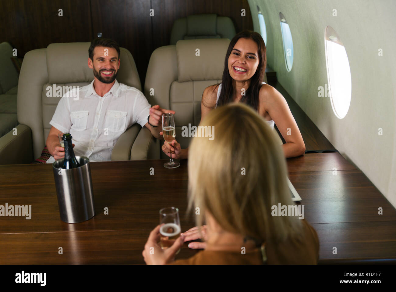 Happy group of friends having party on a luxury private jet Stock Photo ...