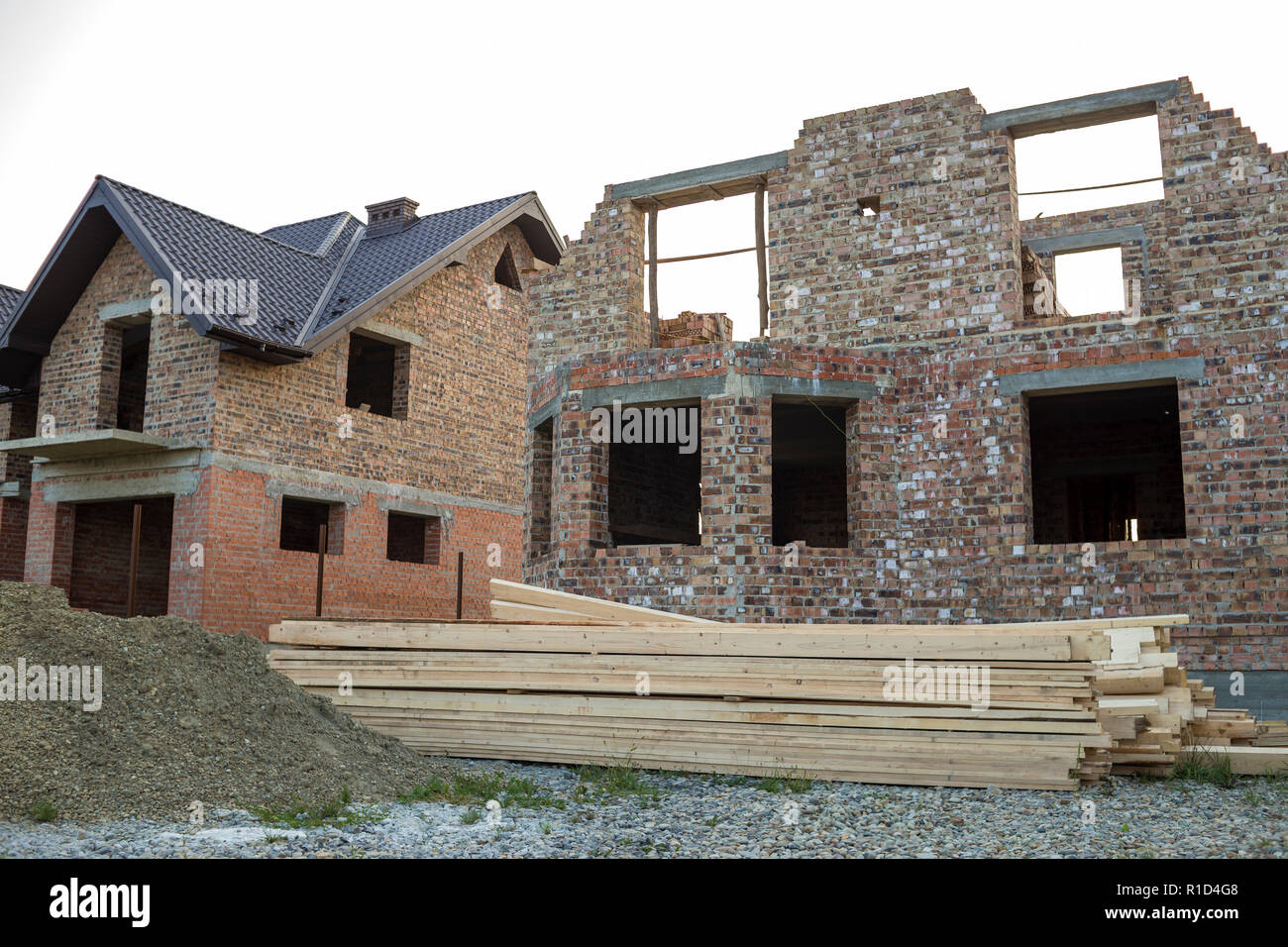 Future cottage under construction and pile of gravel and stack of ...