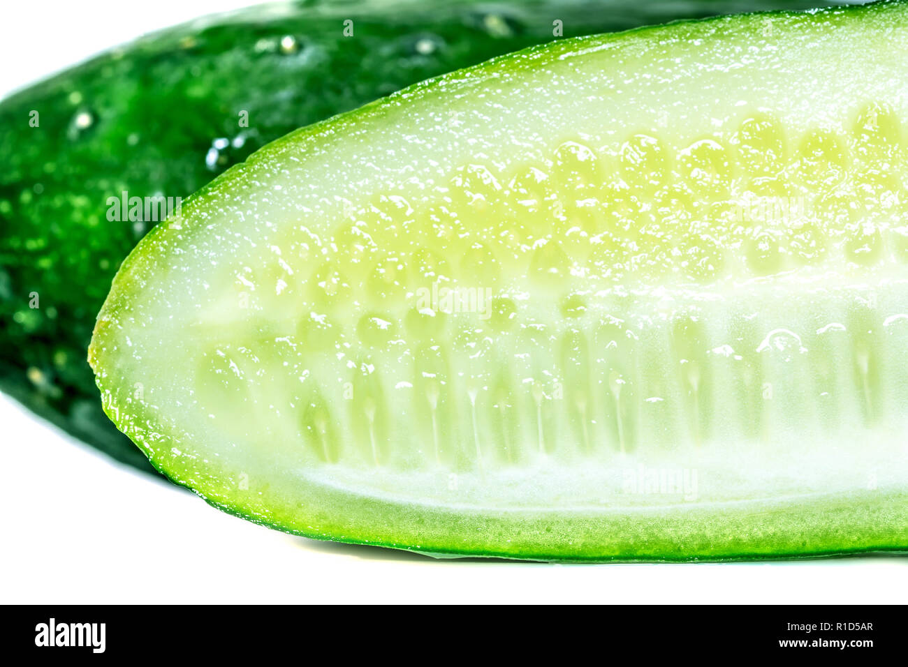 Fresh green cucumber sliced close-up macro isolated on white background ...