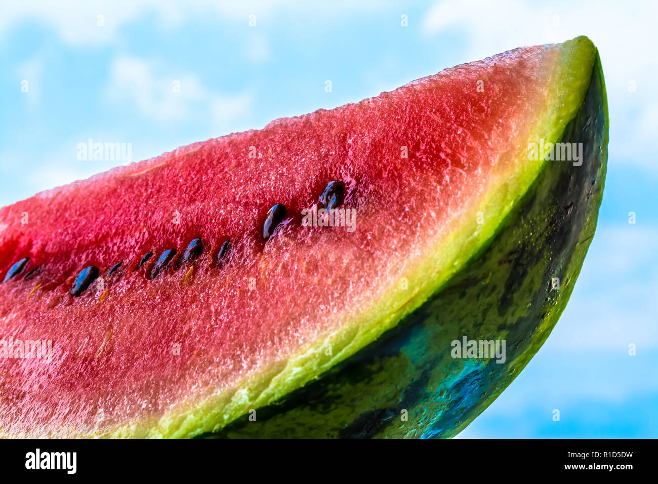 watermelon slice closeup on blue sky background Stock Photo - Alamy