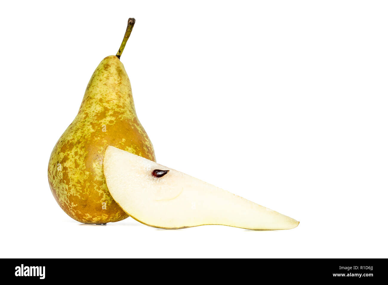 Green whole pear next to a slice piece of pear isolated on white ...