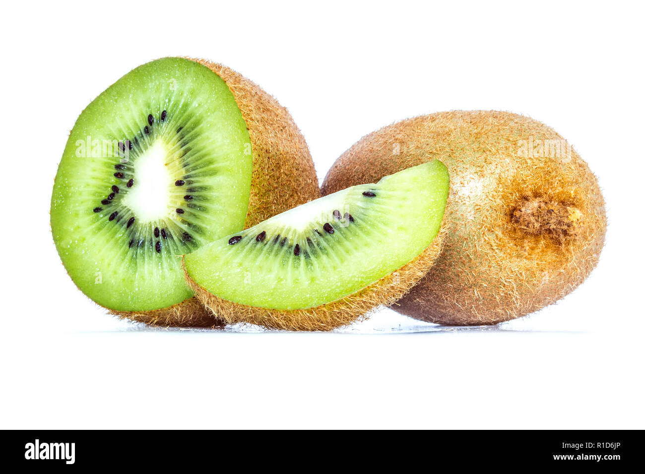 Whole kiwi fruit next to a cut slice kiwi isolated on white background ...