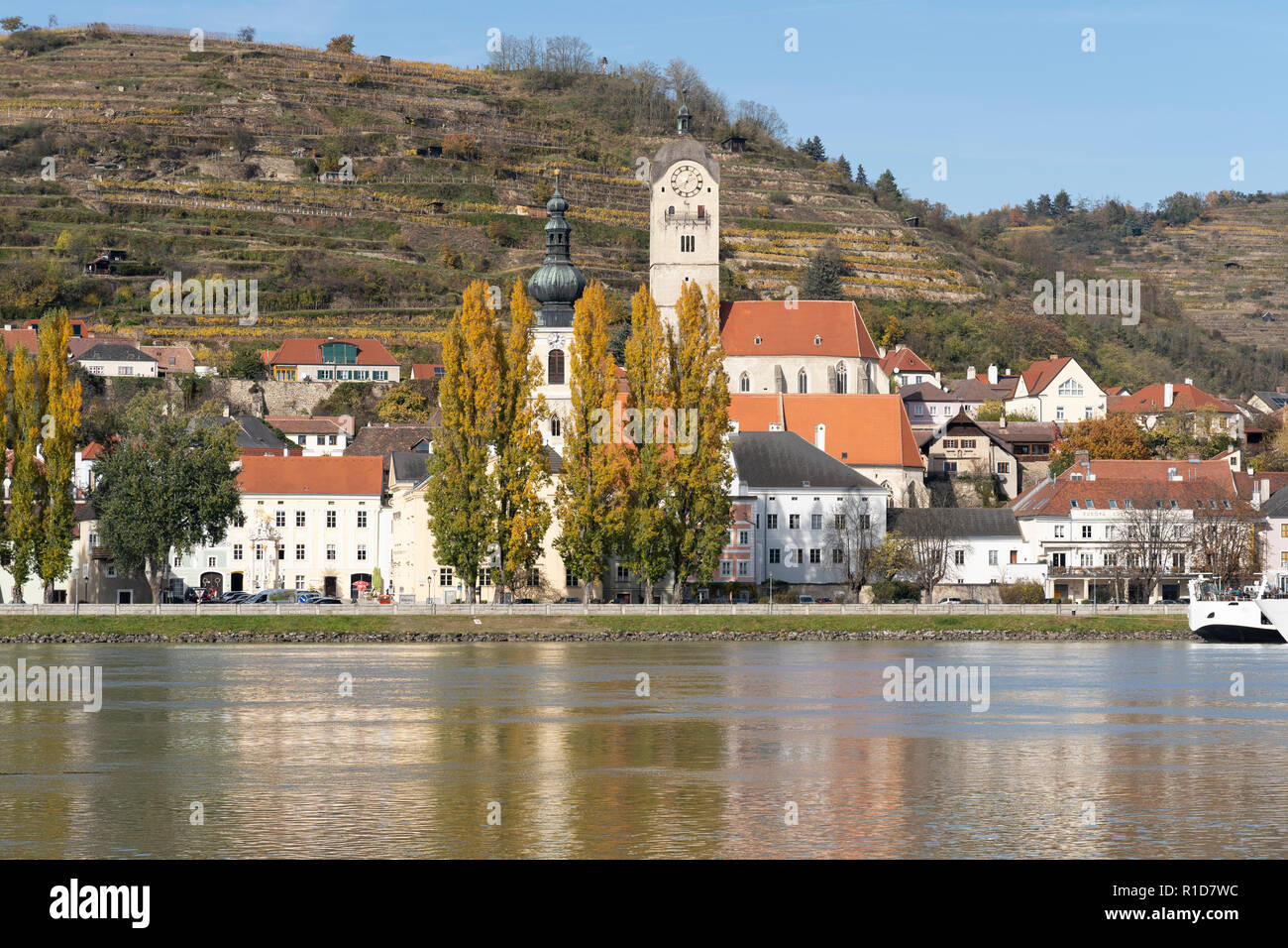 Twin churches reflecting in the River Danube at Stein an der Donau, a ...