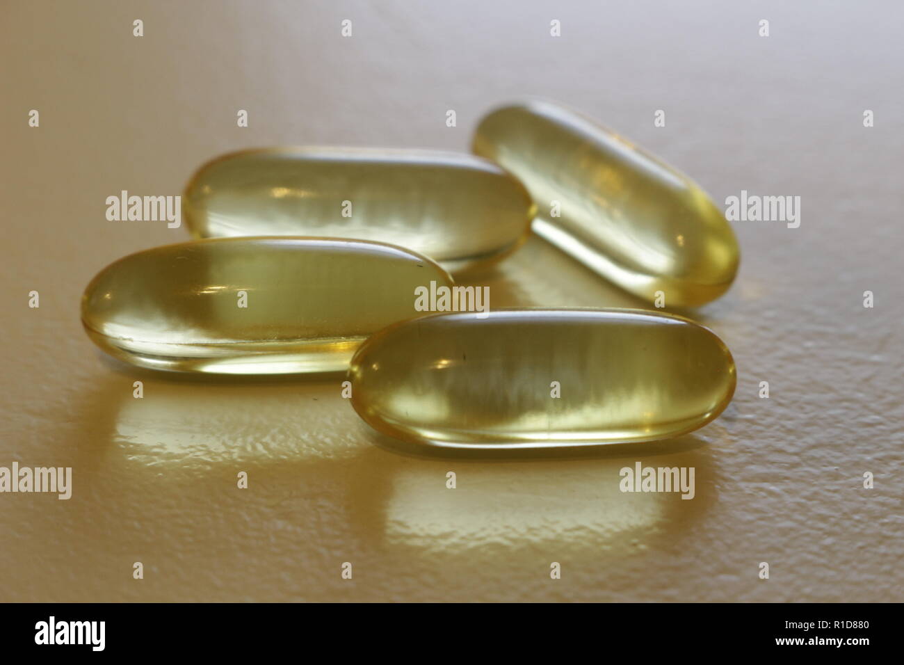 Close up yellow Cod Liver Oil capsule on white background, fish oil is ...
