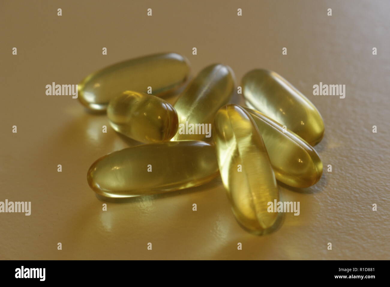 Close up yellow Cod Liver Oil capsule on white background, fish oil is ...
