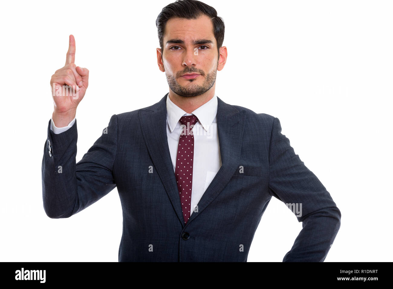 Studio shot of young handsome businessman posing while pointing Stock ...