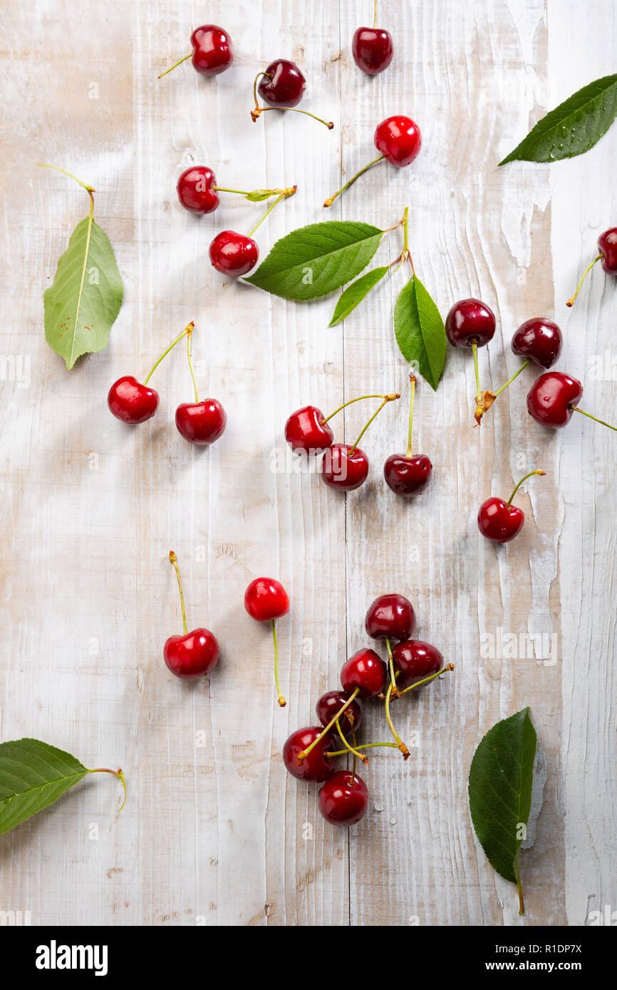 Local cherry on white rustic background Stock Photo - Alamy