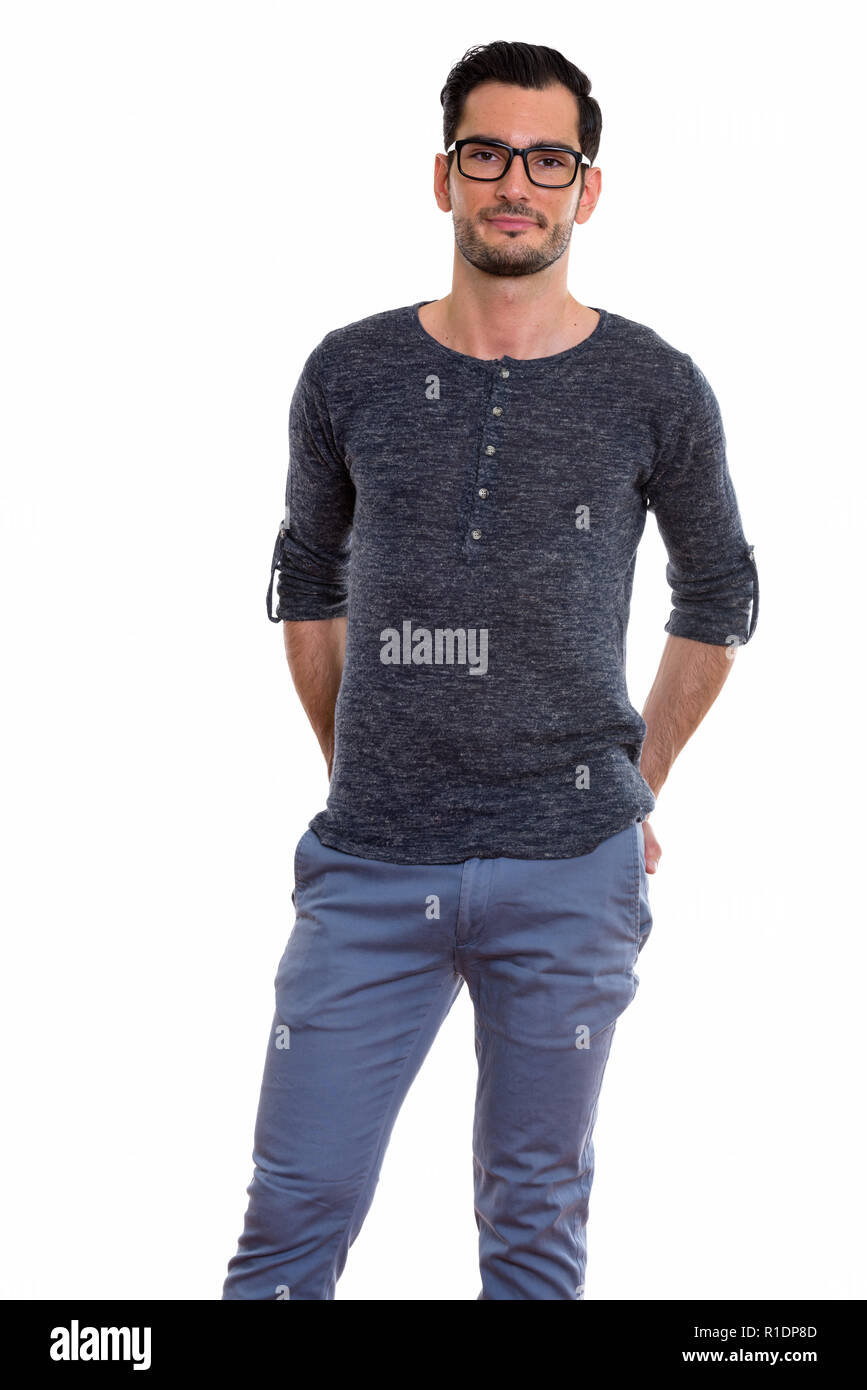Studio shot of young handsome man standing with hands on back po Stock ...