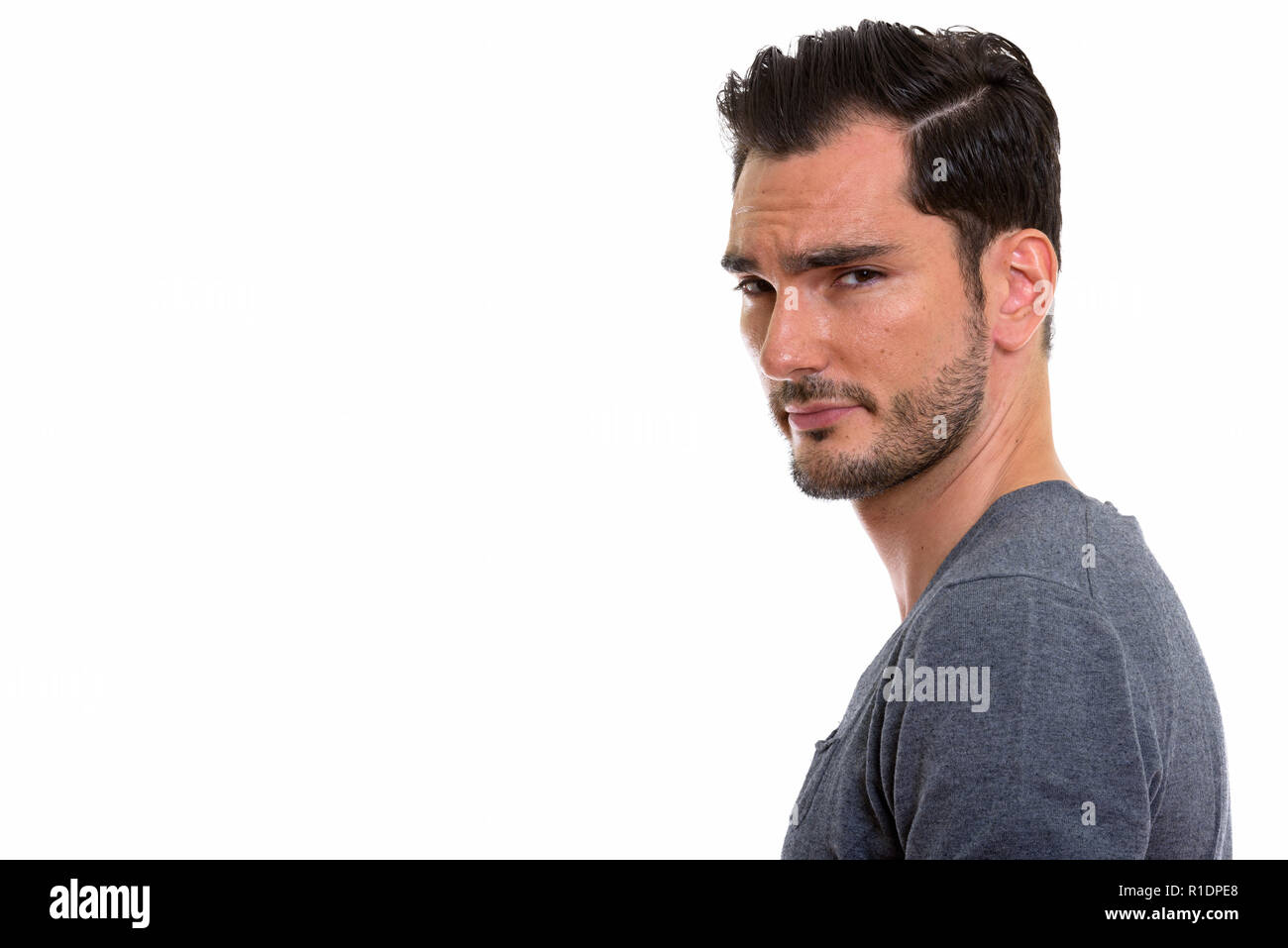 Studio shot of young handsome man looking back Stock Photo - Alamy