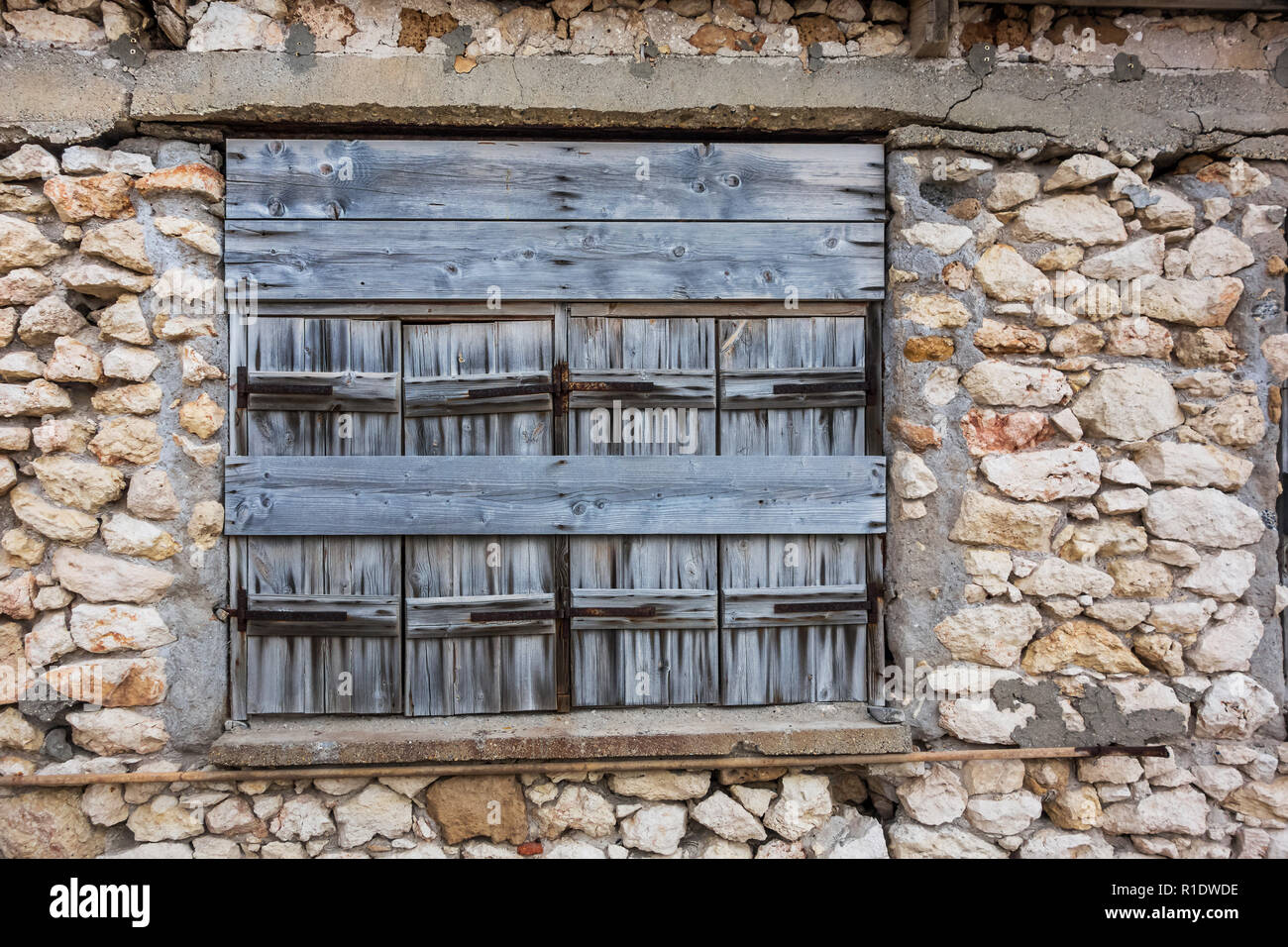 Boarded up old window on stone waii of house Stock Photo - Alamy