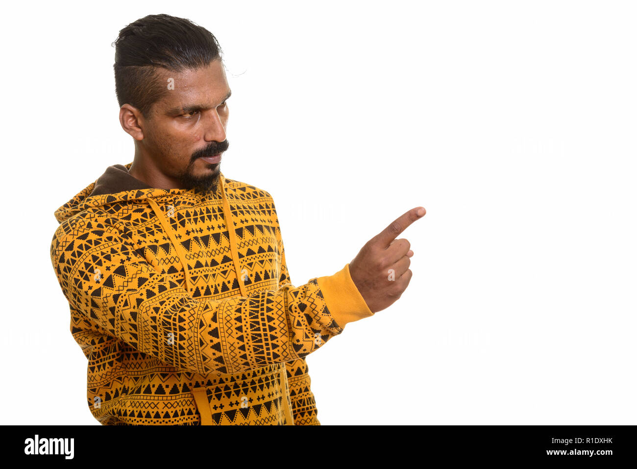 Young Indian man pointing finger studio portrait against white ...