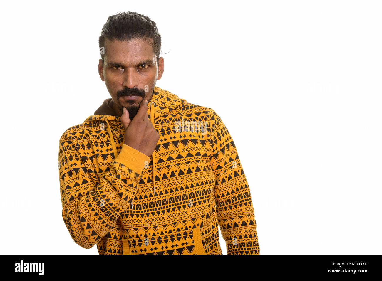 Young Indian man thinking studio portrait against white background ...