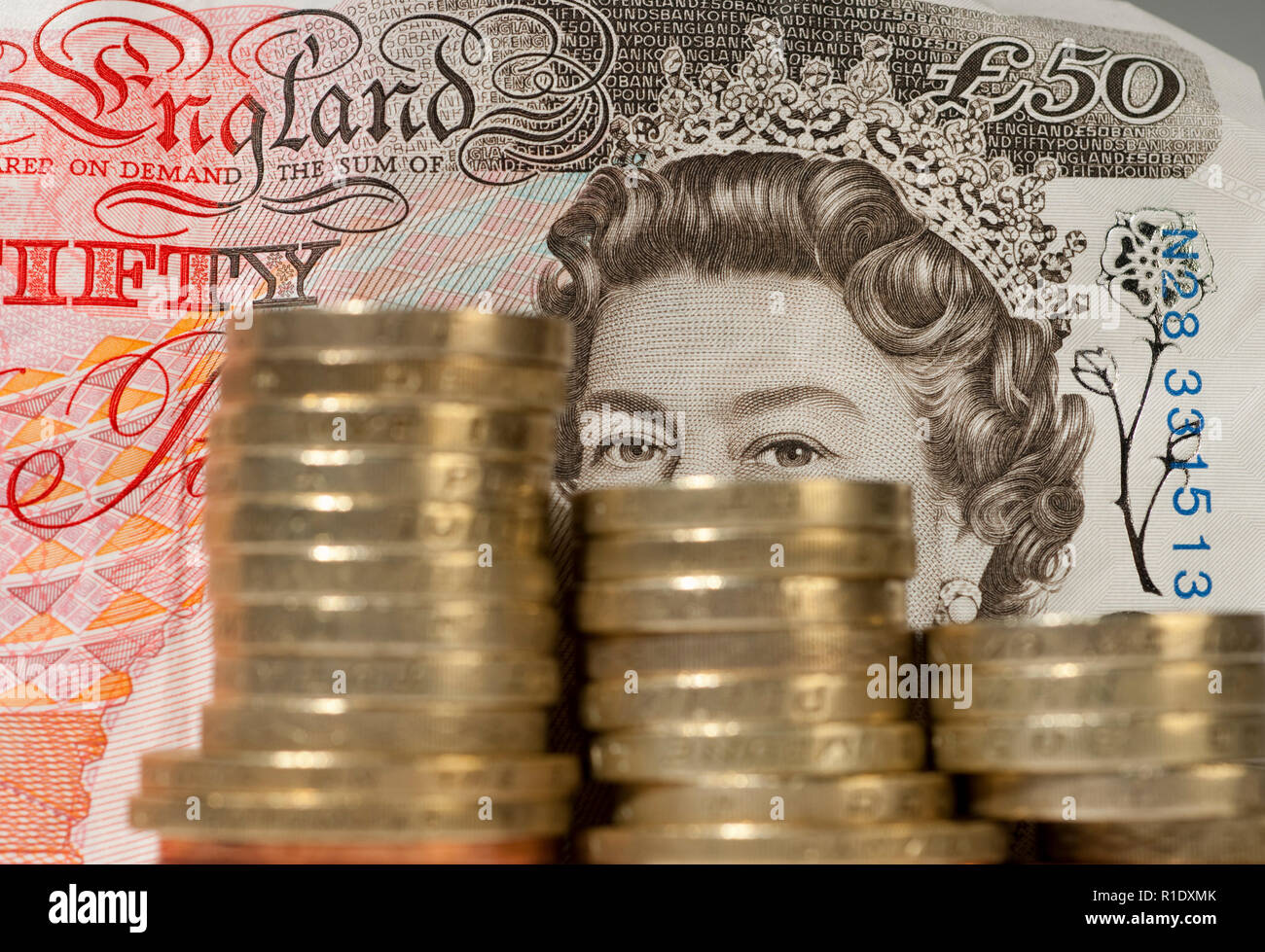 Illustrative image of a £50 note and stacks of pound coins Stock Photo ...