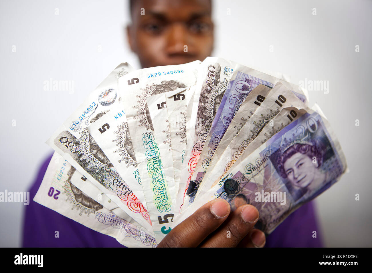 A handful of various denomination pound sterling notes Stock Photo - Alamy
