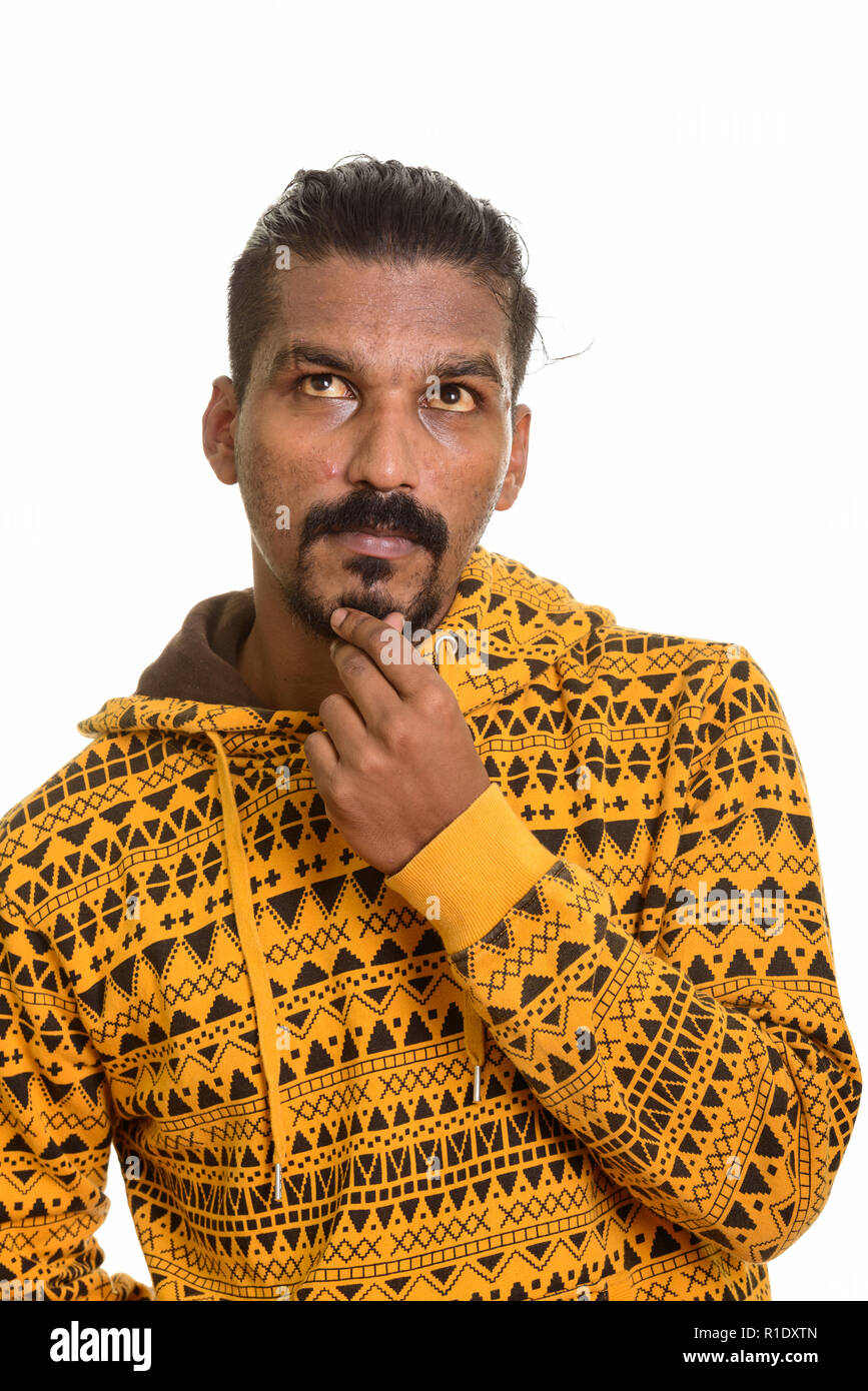 Young Indian man thinking studio portrait against white background ...