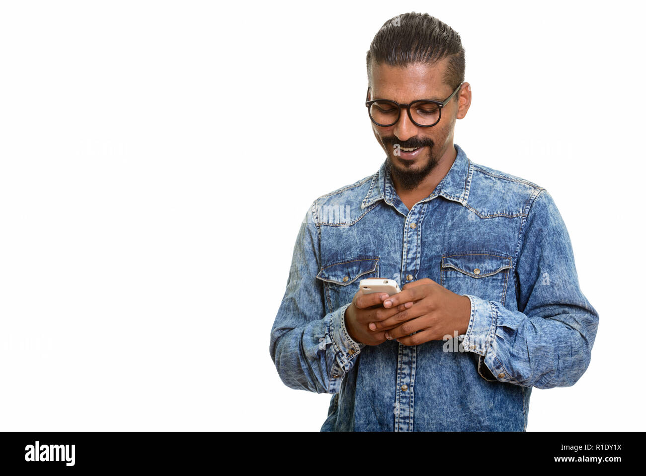 Young happy Indian man using mobile phone Stock Photo - Alamy
