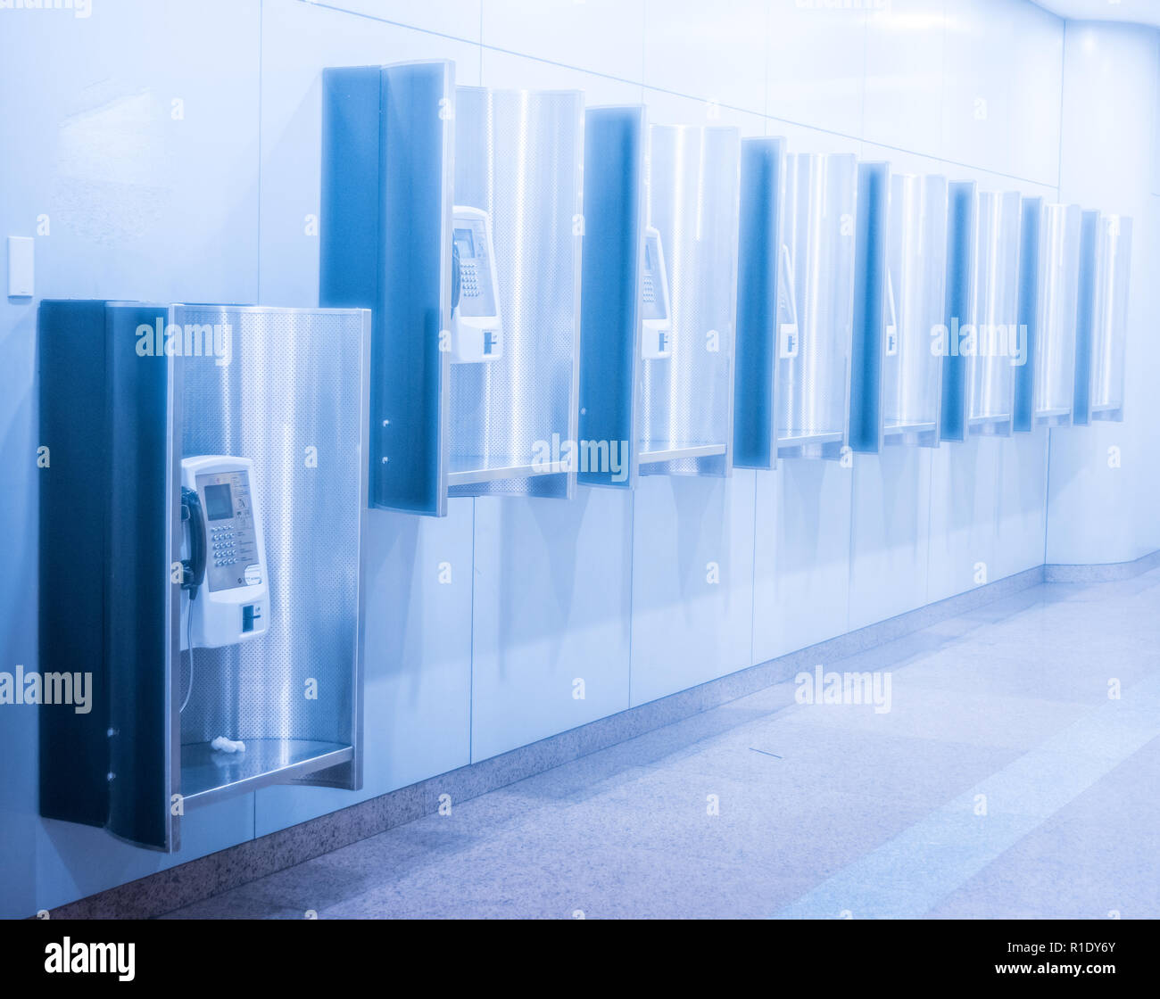 Perspective row of public telephone inside modern building Stock Photo ...