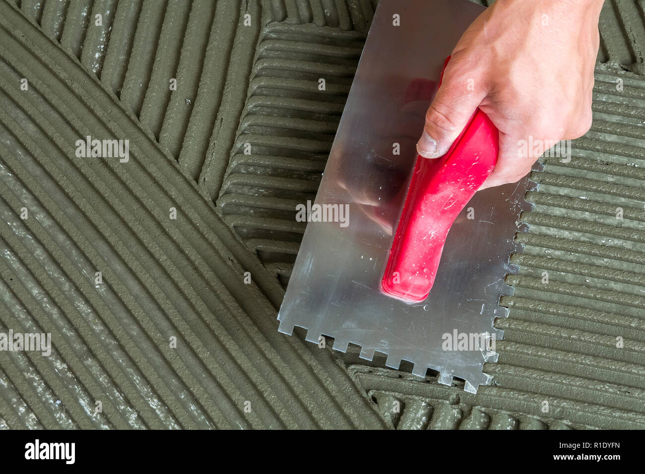 Close-up detail of floor tiles installation. Home improvement ...