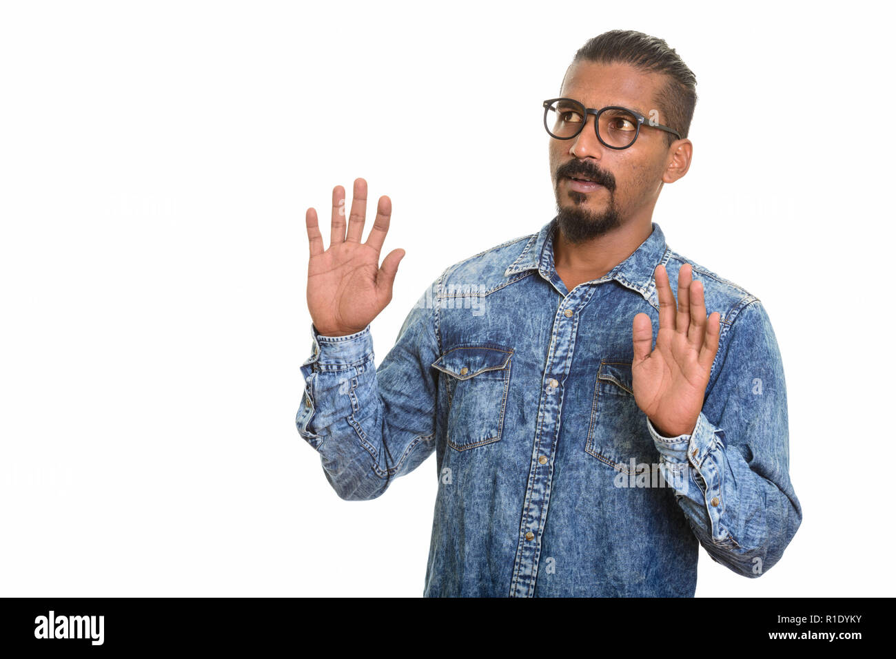 Young Indian man looking shocked studio portrait against white ...