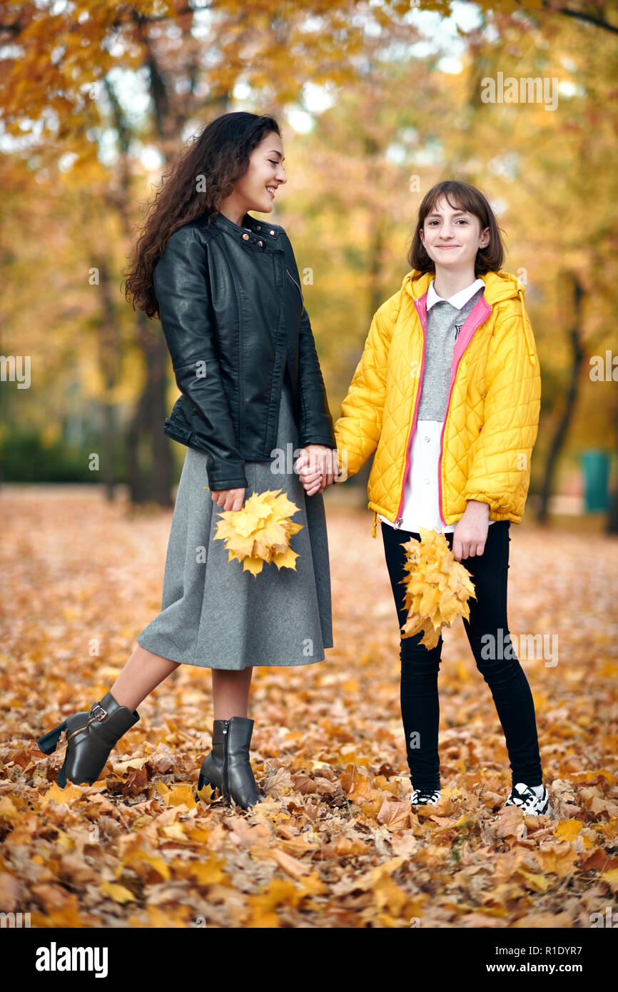 Two girls sister posing in city park hi-res stock photography and ...