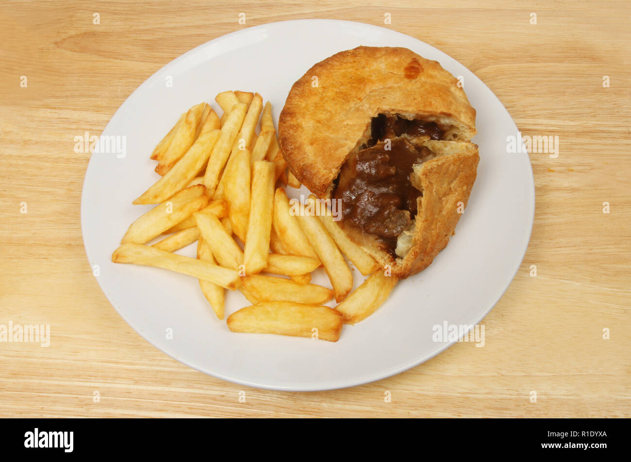Steak pie and chips on a plate ona wooden tabletop Stock Photo - Alamy