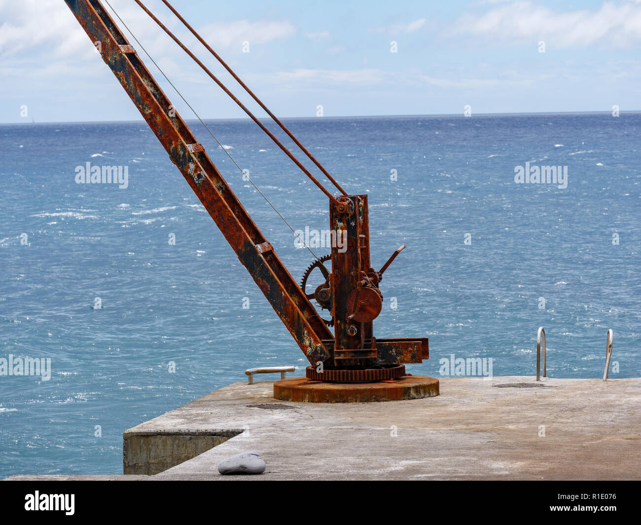 Image of old rusty habour crane on a pier at the sea Azores Portugal ...